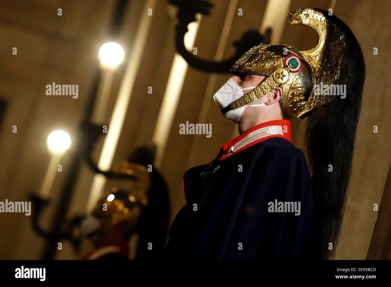 A member of the Corazzieri wears a protective mask stands guard outside ...