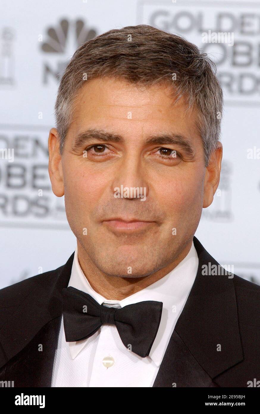 George Clooney poses with his Best Performance by an Actor in a ...