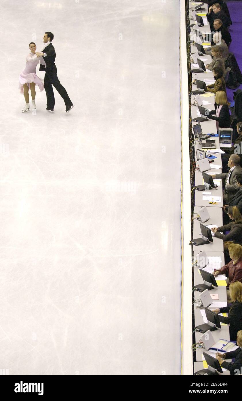 Illustration of skaters in action in front of the judges on pairs free ...