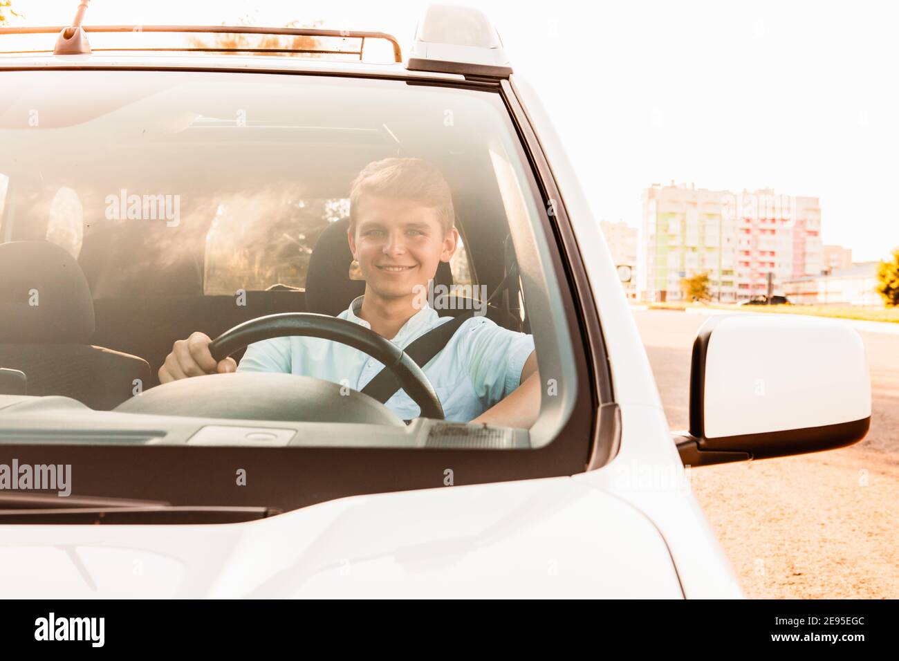 young handsome confident man driving car. road trip Stock Photo - Alamy