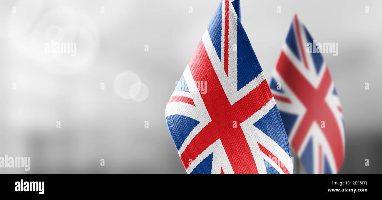 Small national flags of the United Kingdom on a light blurry background ...
