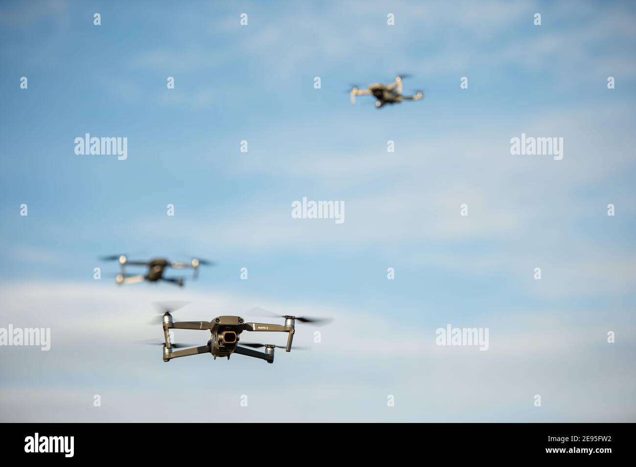Blue sky backdrop with flying drones hi-res stock photography and ...