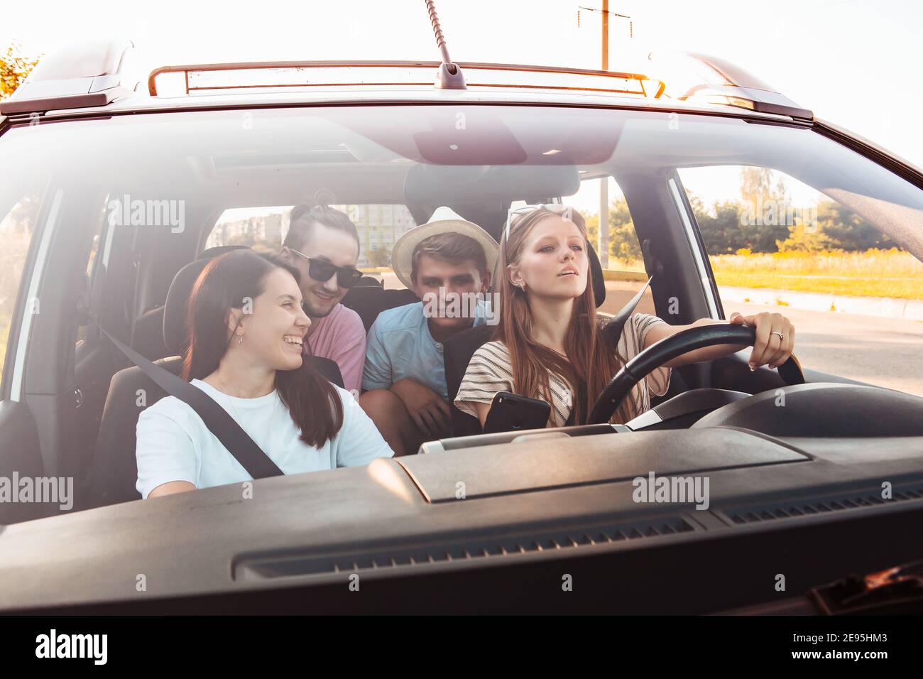 four friends in car navigation on phone. road trip Stock Photo - Alamy