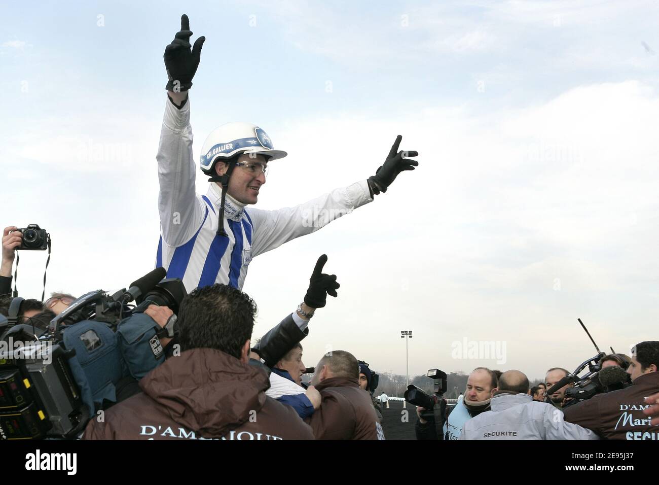 French jockey Christophe Gallier waves to the cheering crowd following ...