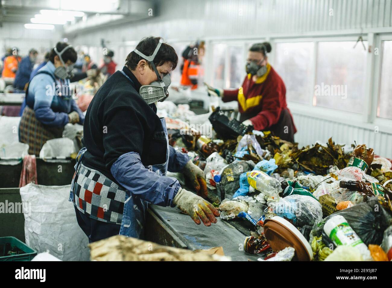 Garbage sorting. Workers sort the garbage Stock Photo - Alamy