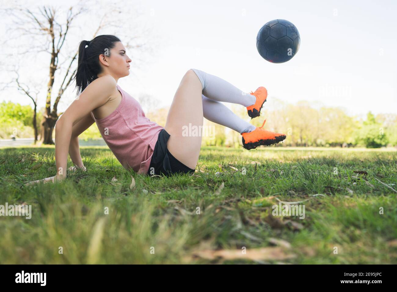 Portrait of young female soccer player training and practicing skills ...
