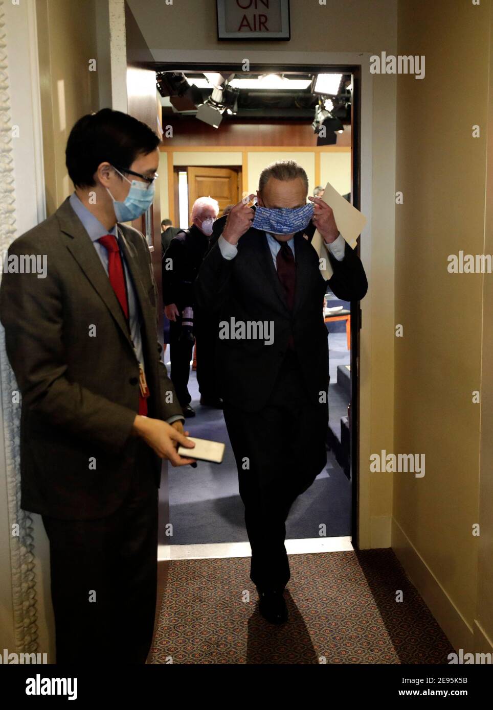 U.S. Senate Majority Leader Chuck Schumer (D-NY) wears a face mask ...