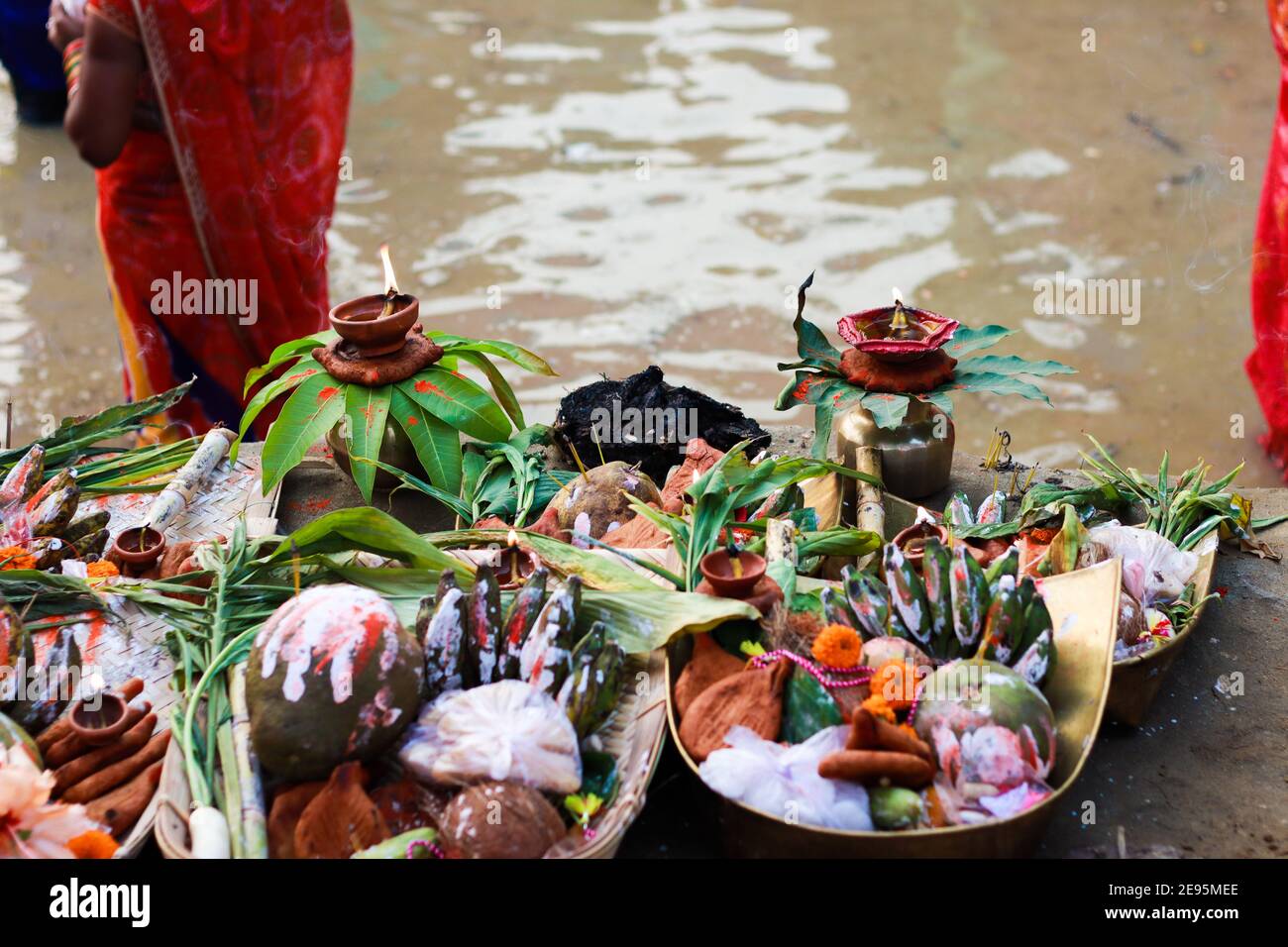 holy offerings of fruits flowers lamps and cloths in river to sun god ...