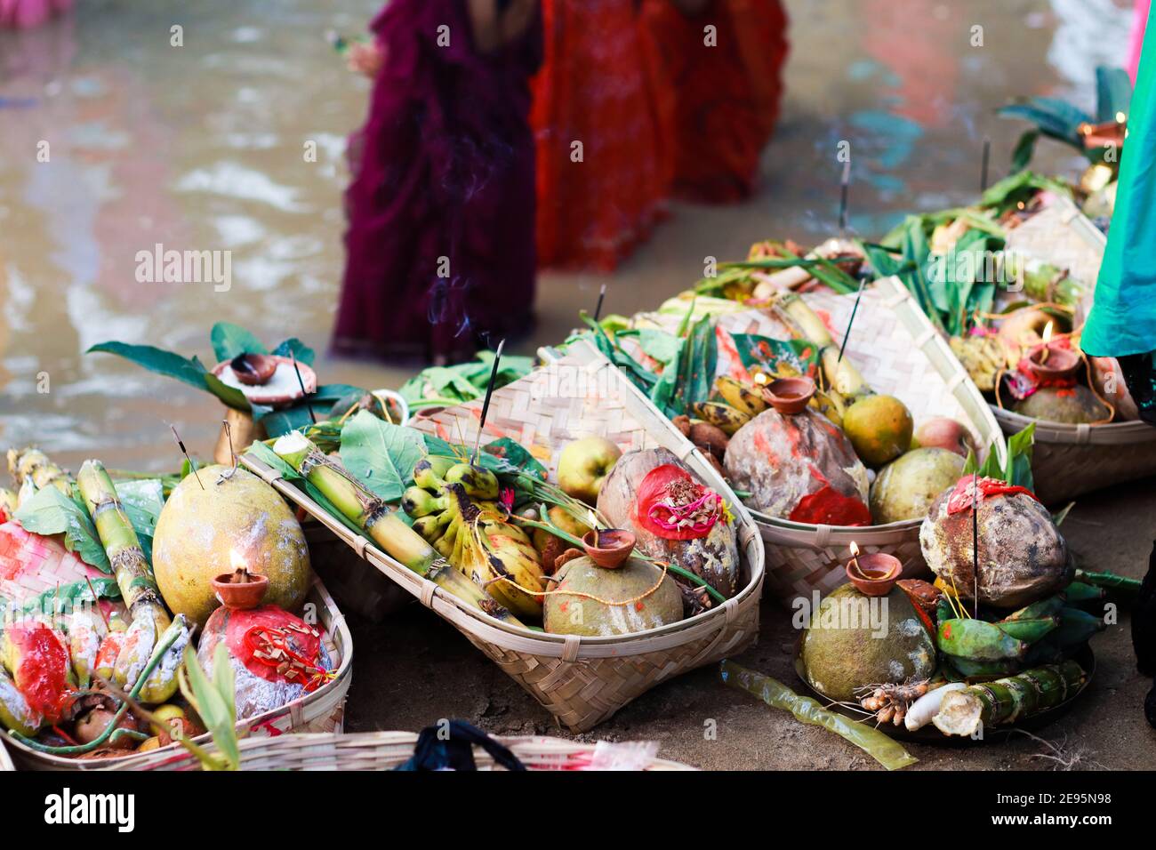 holy offerings of fruits flowers lamps and cloths in river to sun god ...