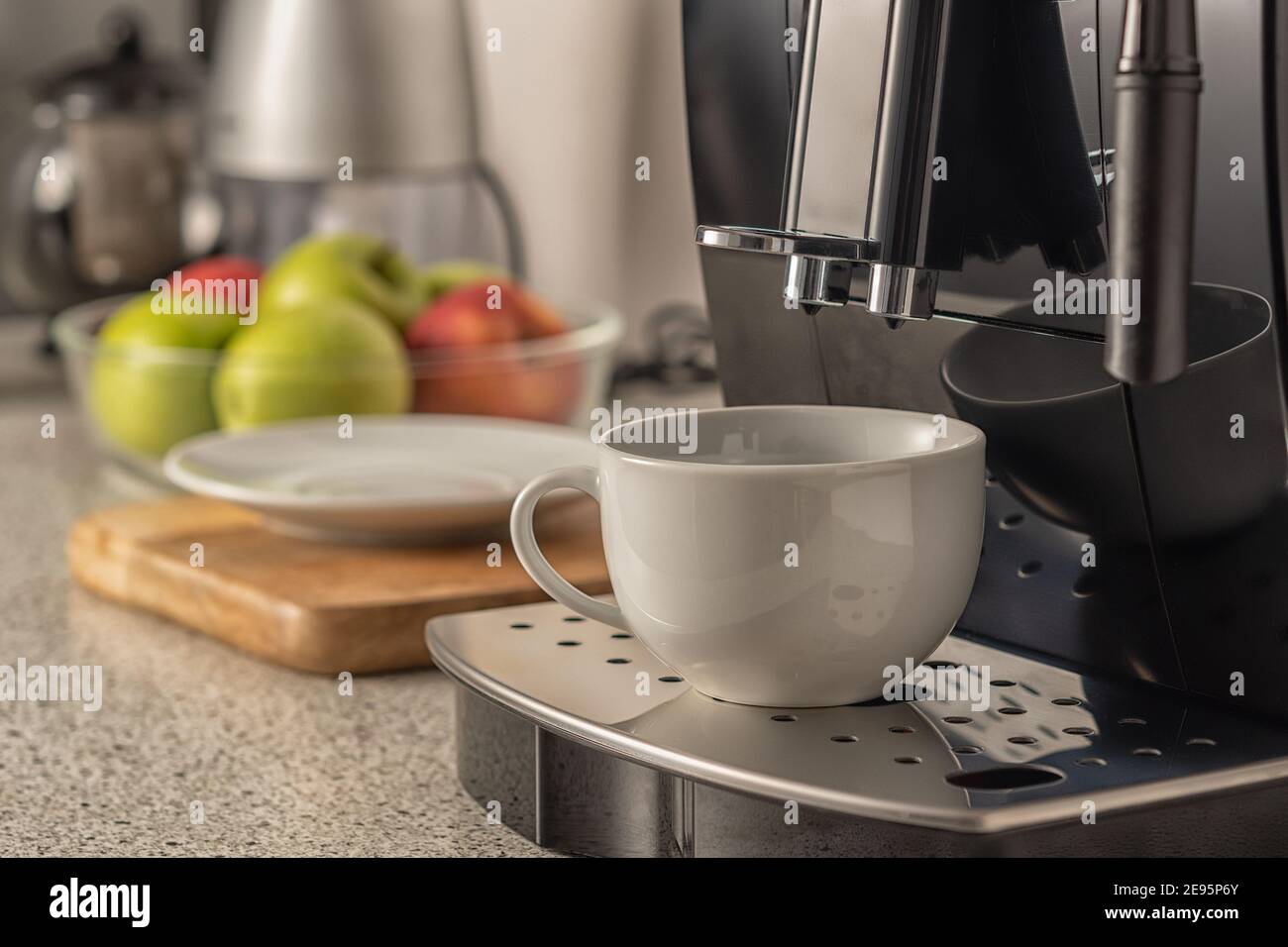 Modern espresso coffee machine with a cup in interior of kitchen ...