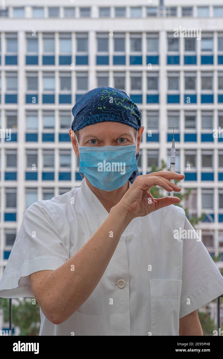 Paris, France - 31 01 2021: Masked nurse dressed in a white lab coat ...