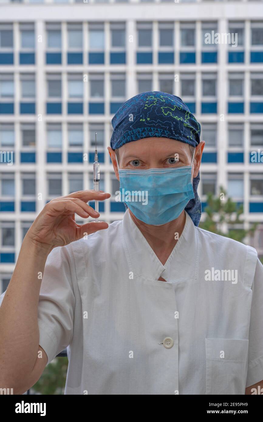 Paris, France - 31 01 2021: Masked nurse dressed in a white lab coat ...