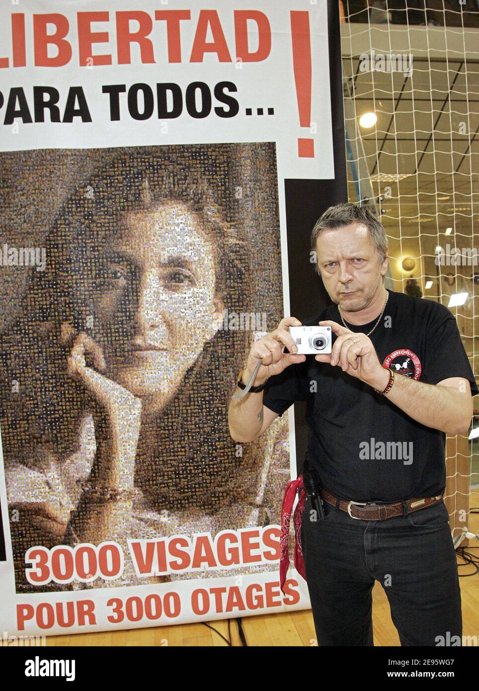 French singer Renaud Sechan poses in front of a poster of Ingrid ...