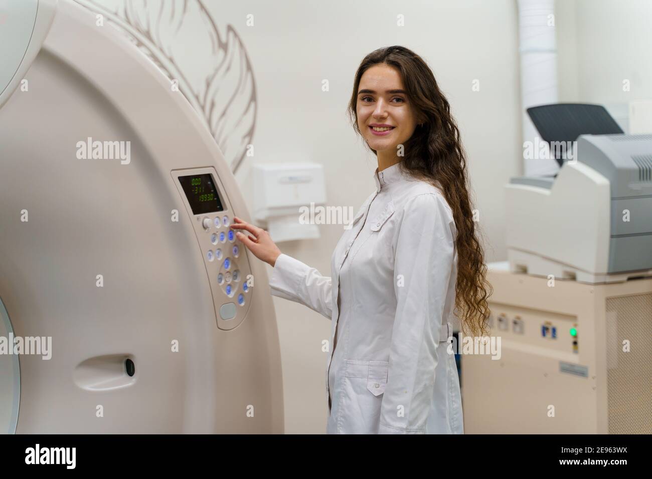 Medical doctor does computer tomography fot patient. Young girl in ...