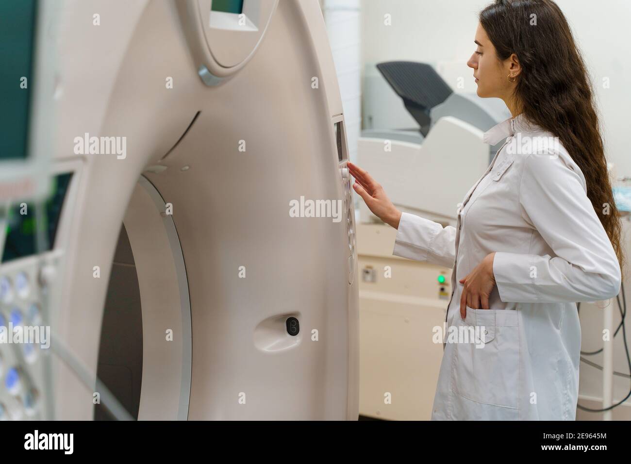 Medical doctor does computer tomography fot patient. Young girl in ...