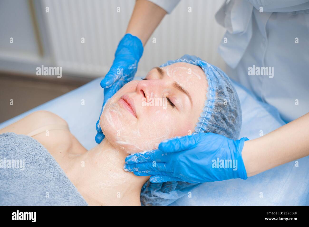 Spa procedure. Facial massage and spreading cream. Cosmetic skin care ...