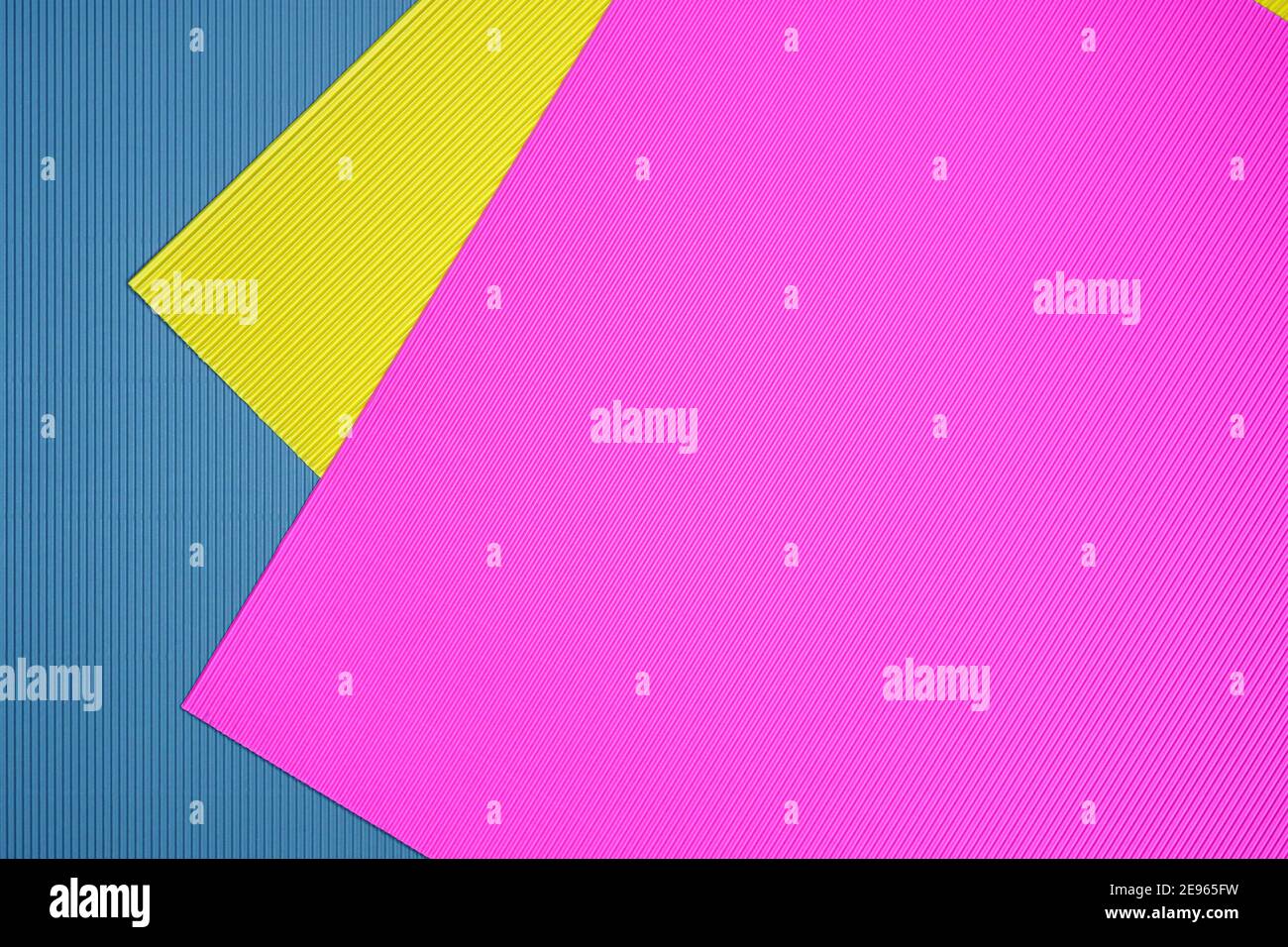 Blue, pink and yellow three tone color paper background with stripes ...