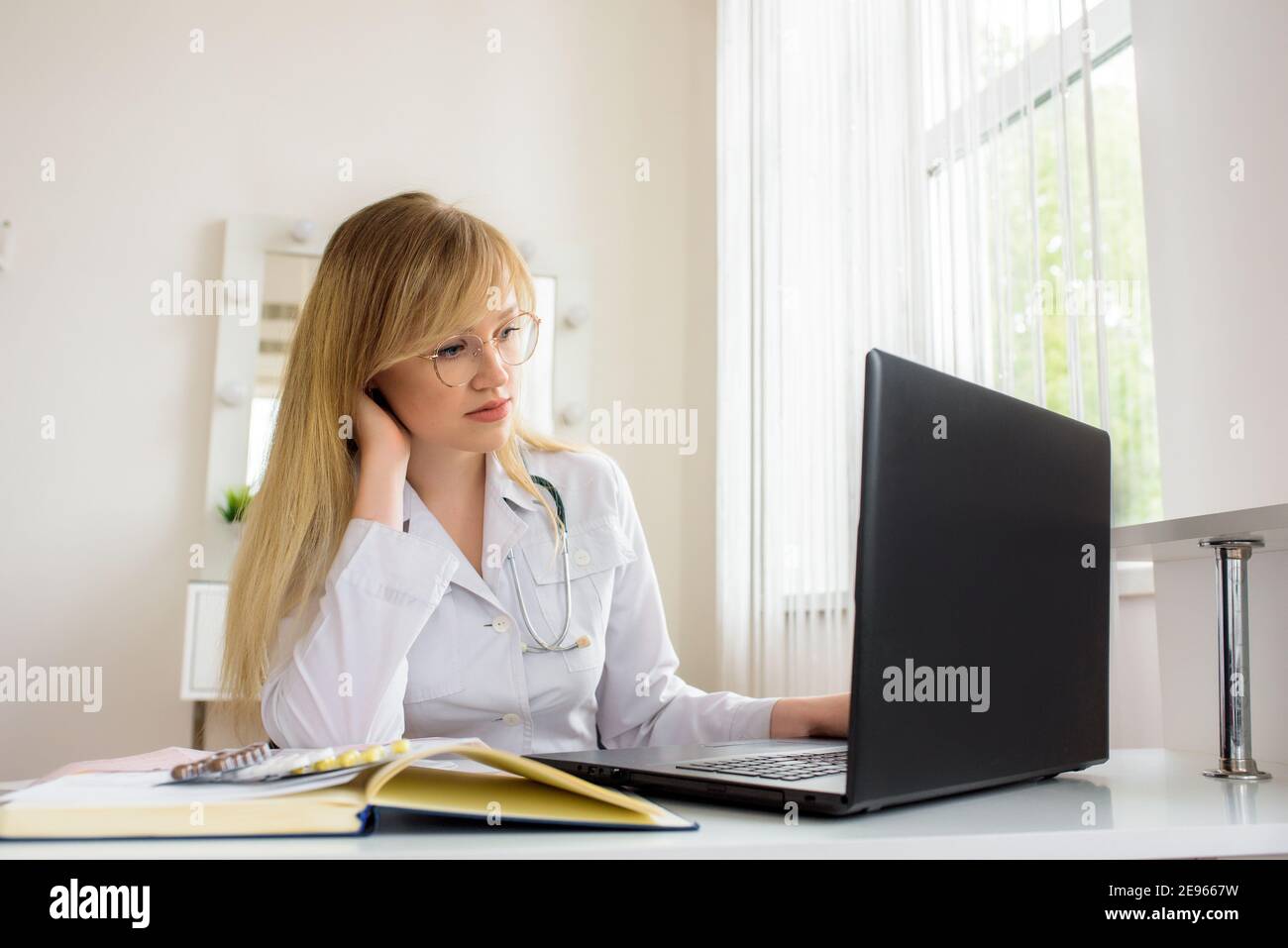 young stressed woman doctor sitting in modern office.tired doctor at ...