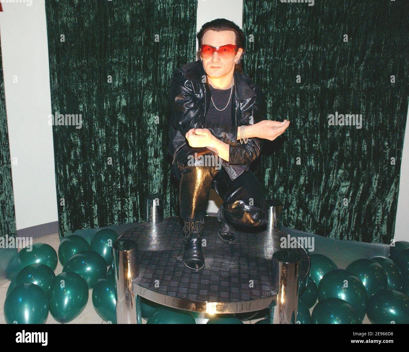 U2's lead singer Bono has his wax figure unveiled amid a sea of green ...