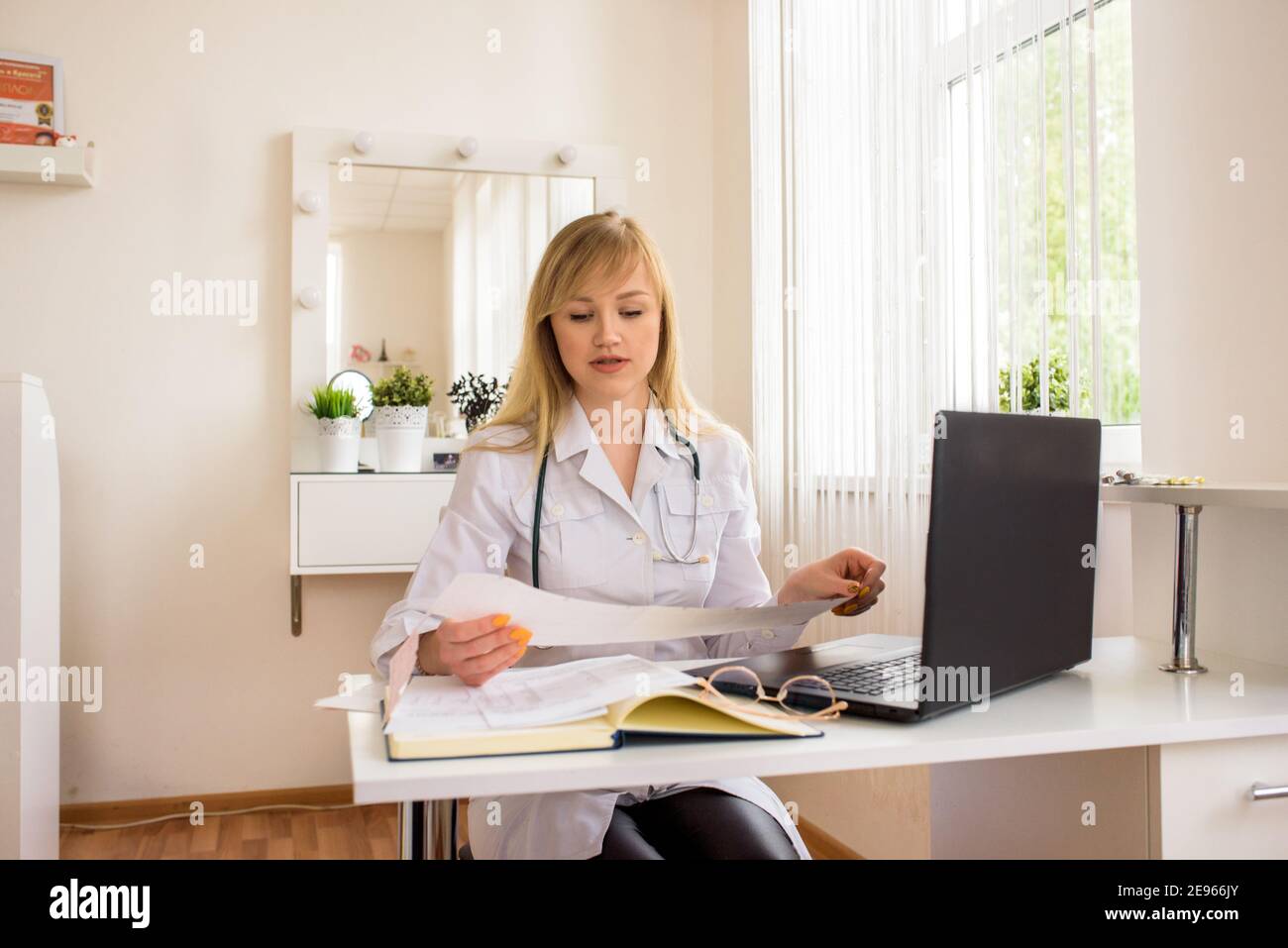 Online consultation.female doctor work with computer and pape note in ...