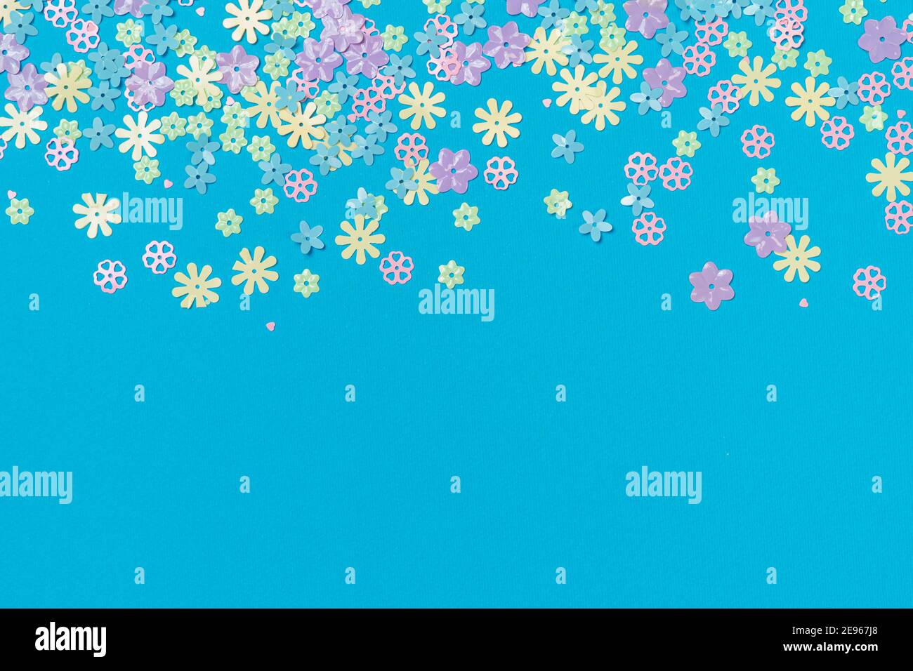 Festive blue background with colorful flowers with copy space. Multi ...