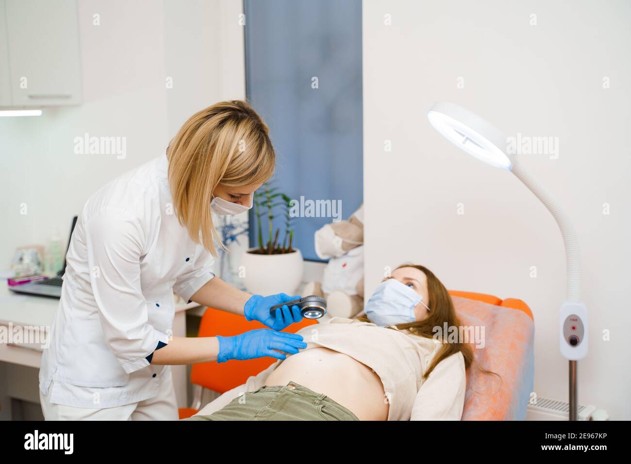 Dermatologist makes an examination using a dermatoscope. Consultation ...