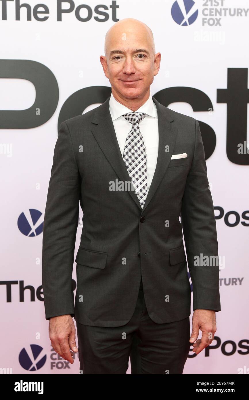 Jeff bezos poses as he arrives on the red carpet for 'The Post' premier ...