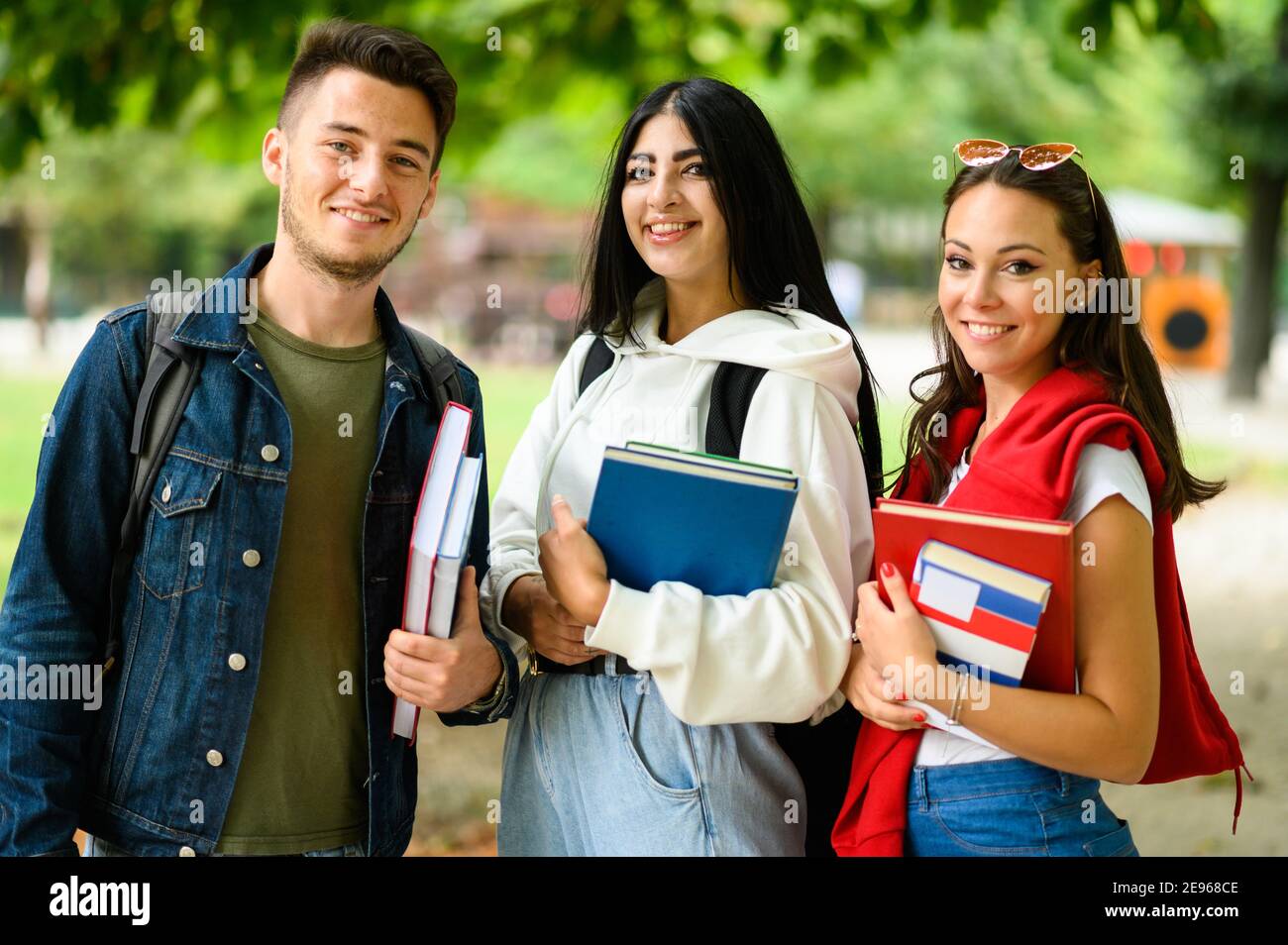 Happy students outdoor smiling together Stock Photo - Alamy