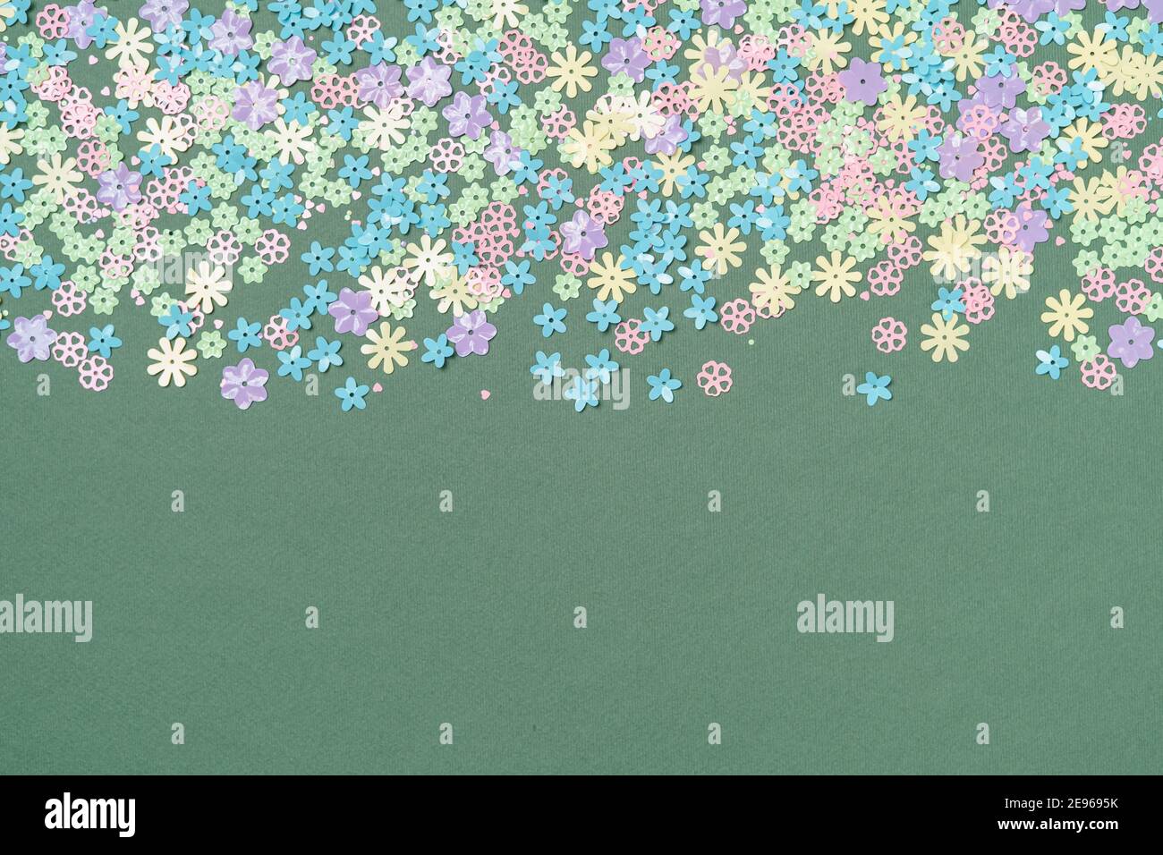 Festive green background with colorful flowers with copy space. Multi ...