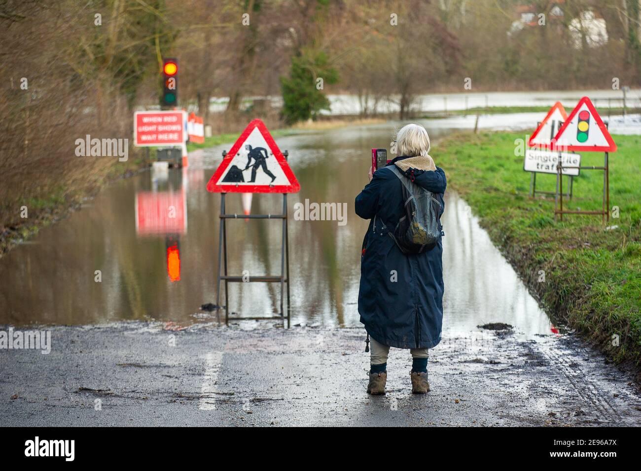 Cookham, Berkshire, UK. 2nd February, 2021. A lady stops to take photos ...