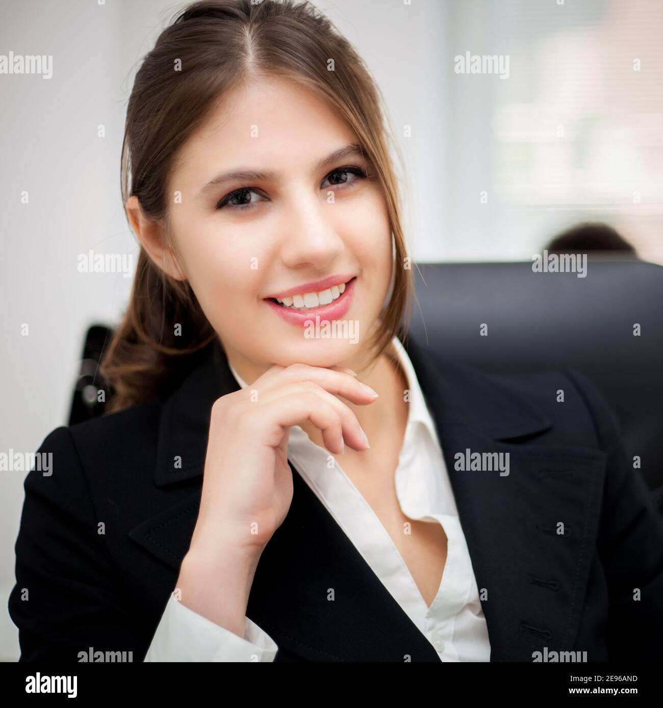 Young secretary at her desk in a modern office Stock Photo - Alamy