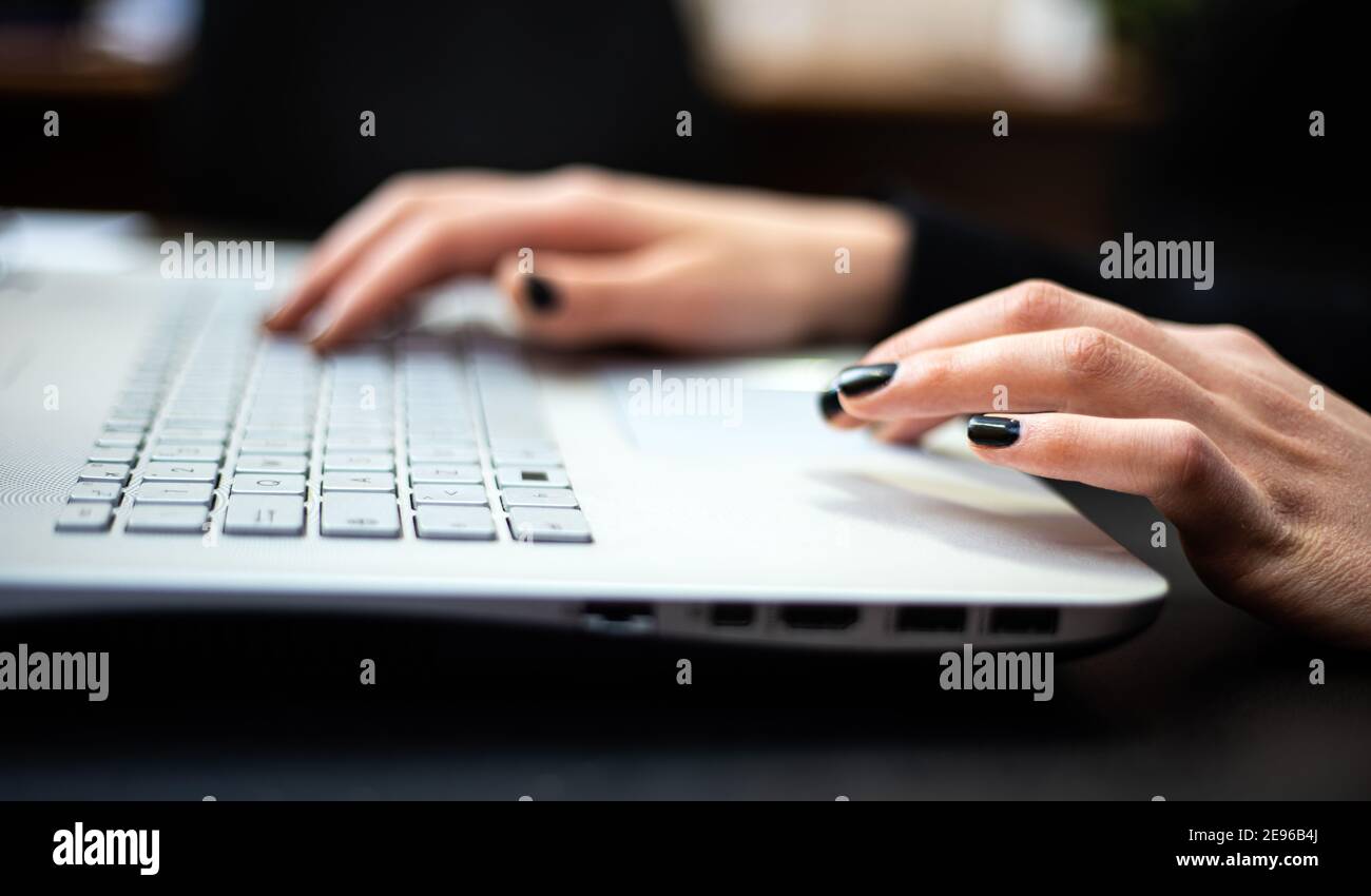 Businesswoman typing on laptop at workplace Stock Photo - Alamy