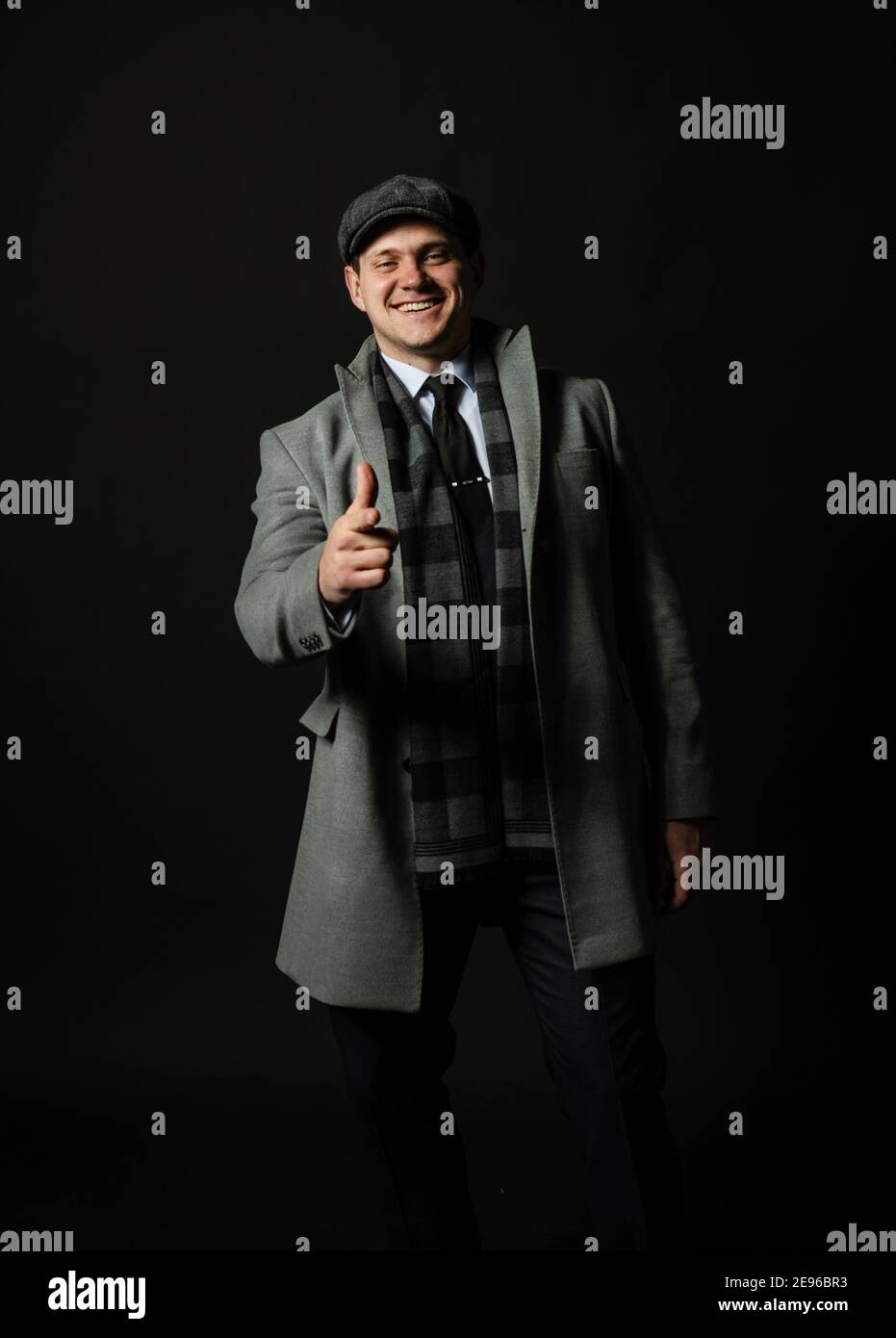 in a coat and a cap a scarf Young man three piece suit fashion, young ...