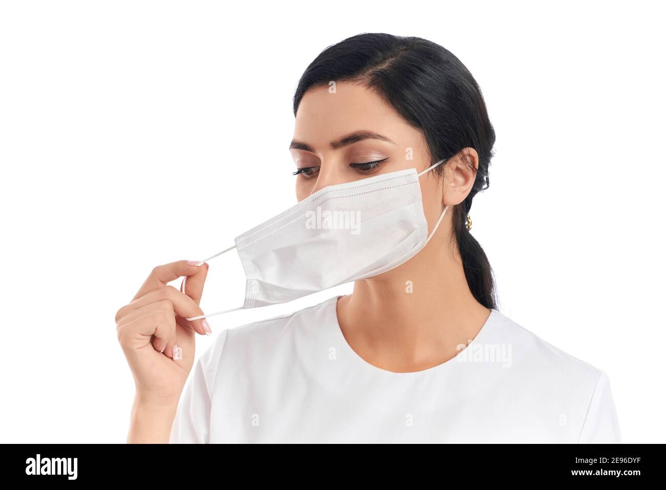 Portrait of attractive young woman with dark hair getting off medical ...