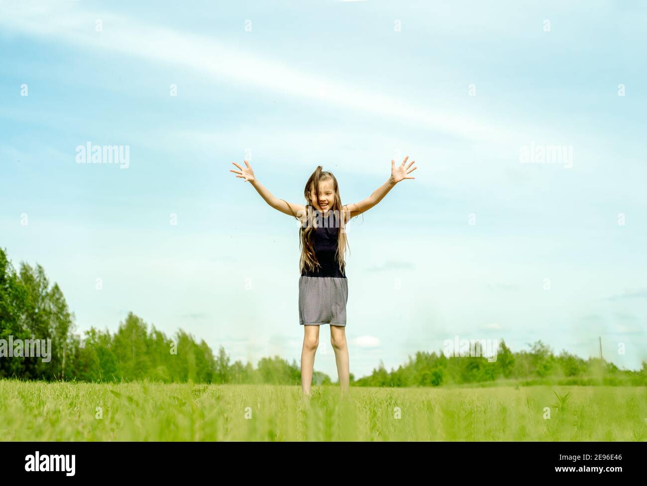 Little girl running on a meadow in a field of flowers, Freedom ...