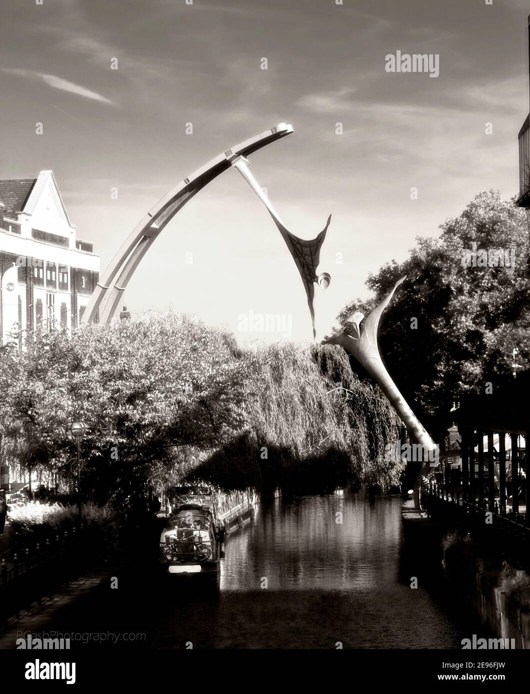 Public art sculpture crossing over river or canal, reaching out to each ...