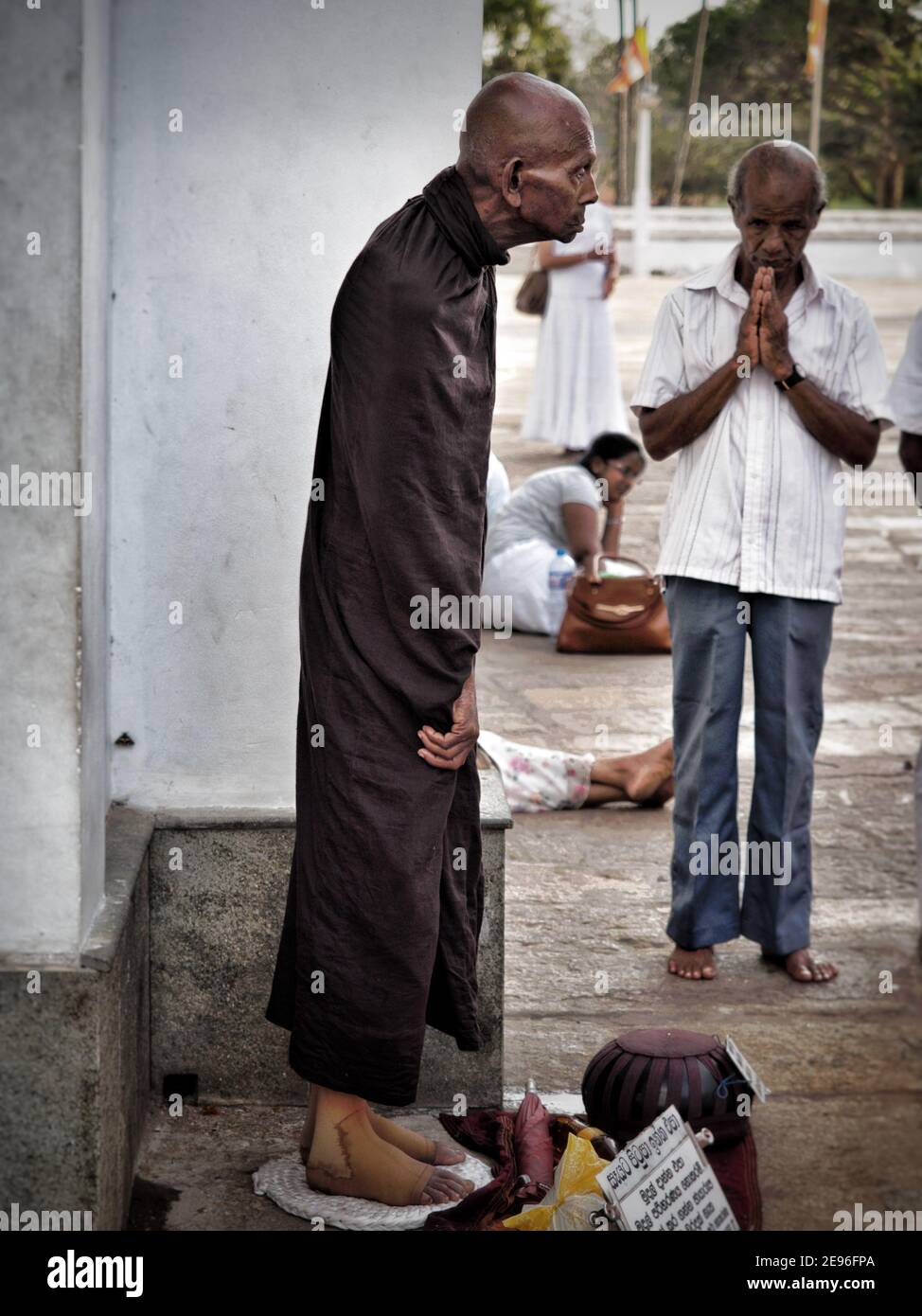 ANURADHAPURA, SRI LANKA - March 9, 2019: Old south asian Monk praying ...