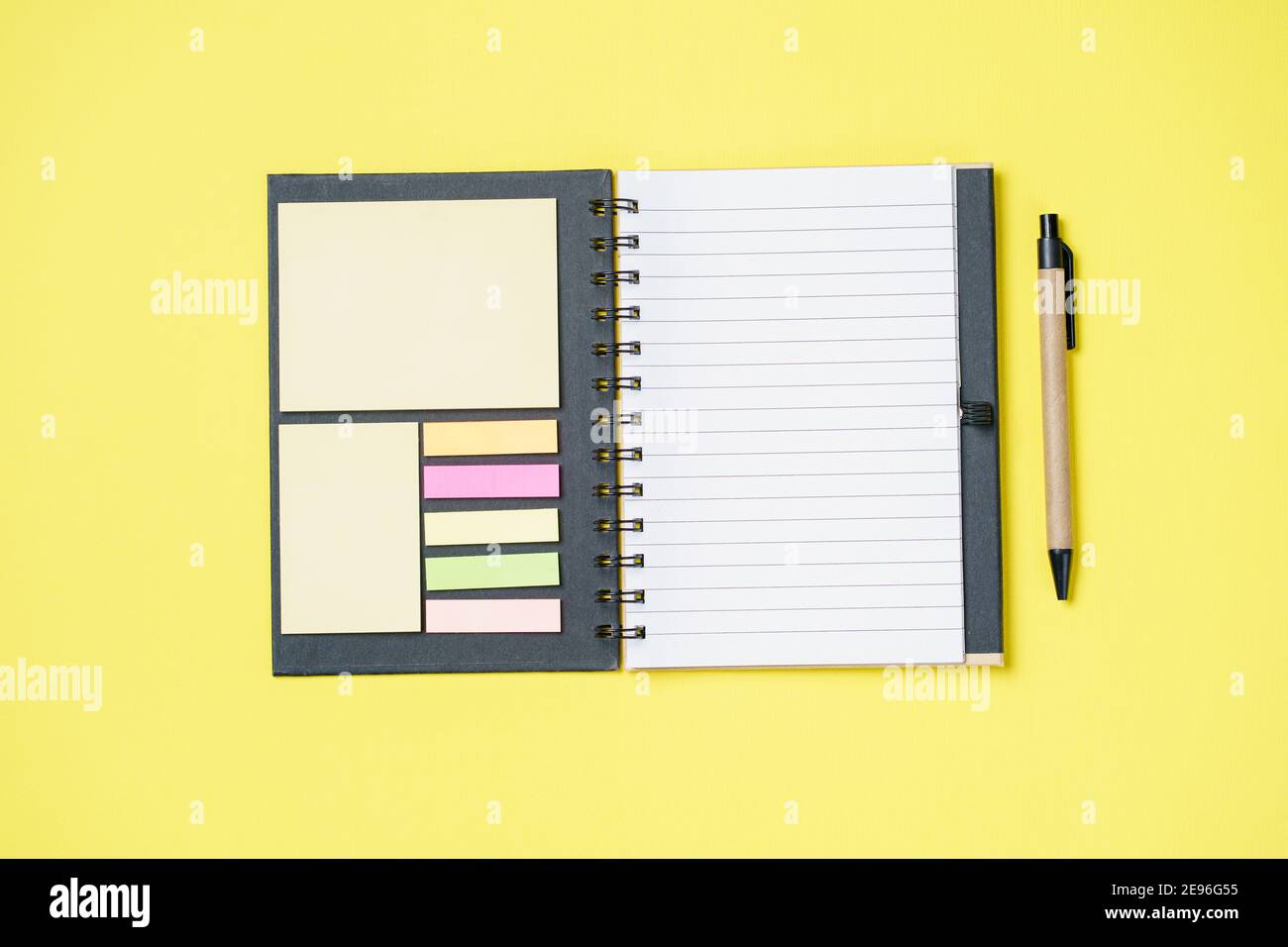 School notebook on a paper yellow background, spiral notepad and craft ...