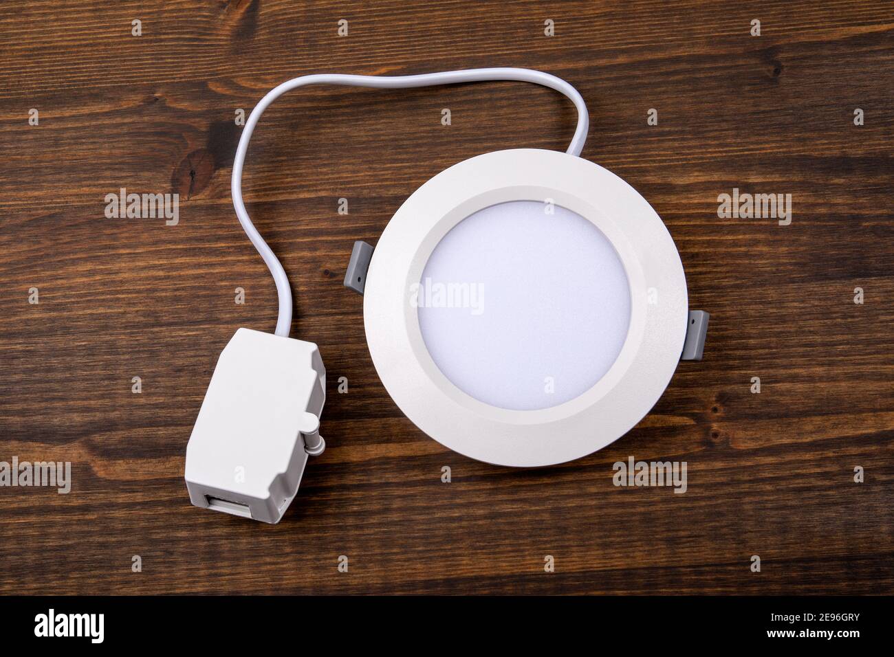 Led luminaire in white on a wooden texture background Stock Photo - Alamy