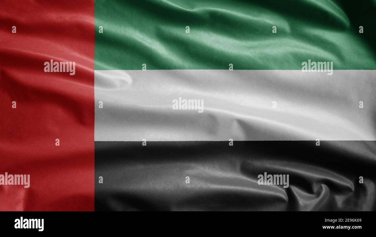 United Arab Emirates flag waving in the wind. Close up of UAE banner ...