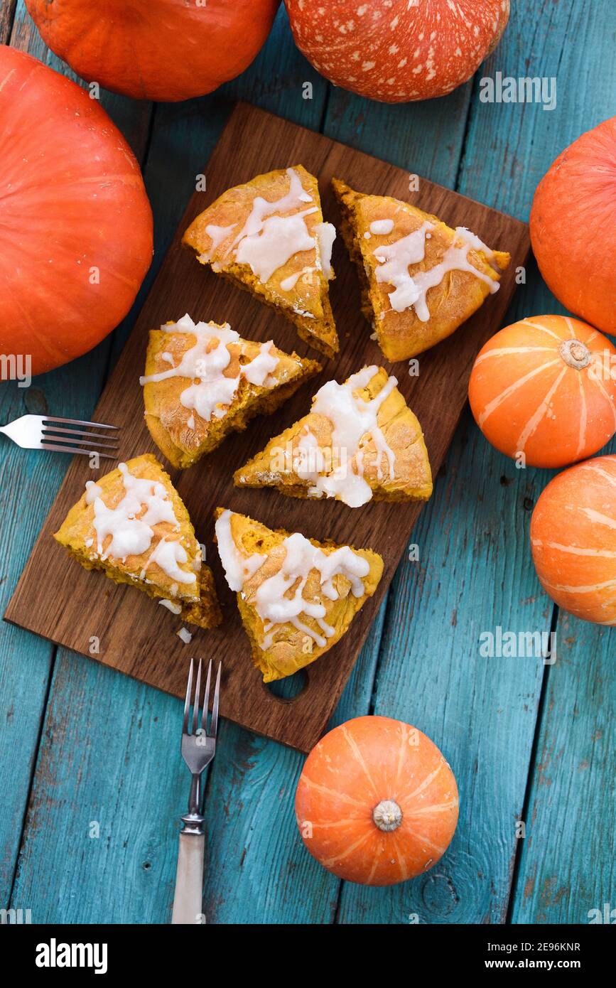 Homemade pumpkin pastry. Traditional triangular scones with sugar icing ...