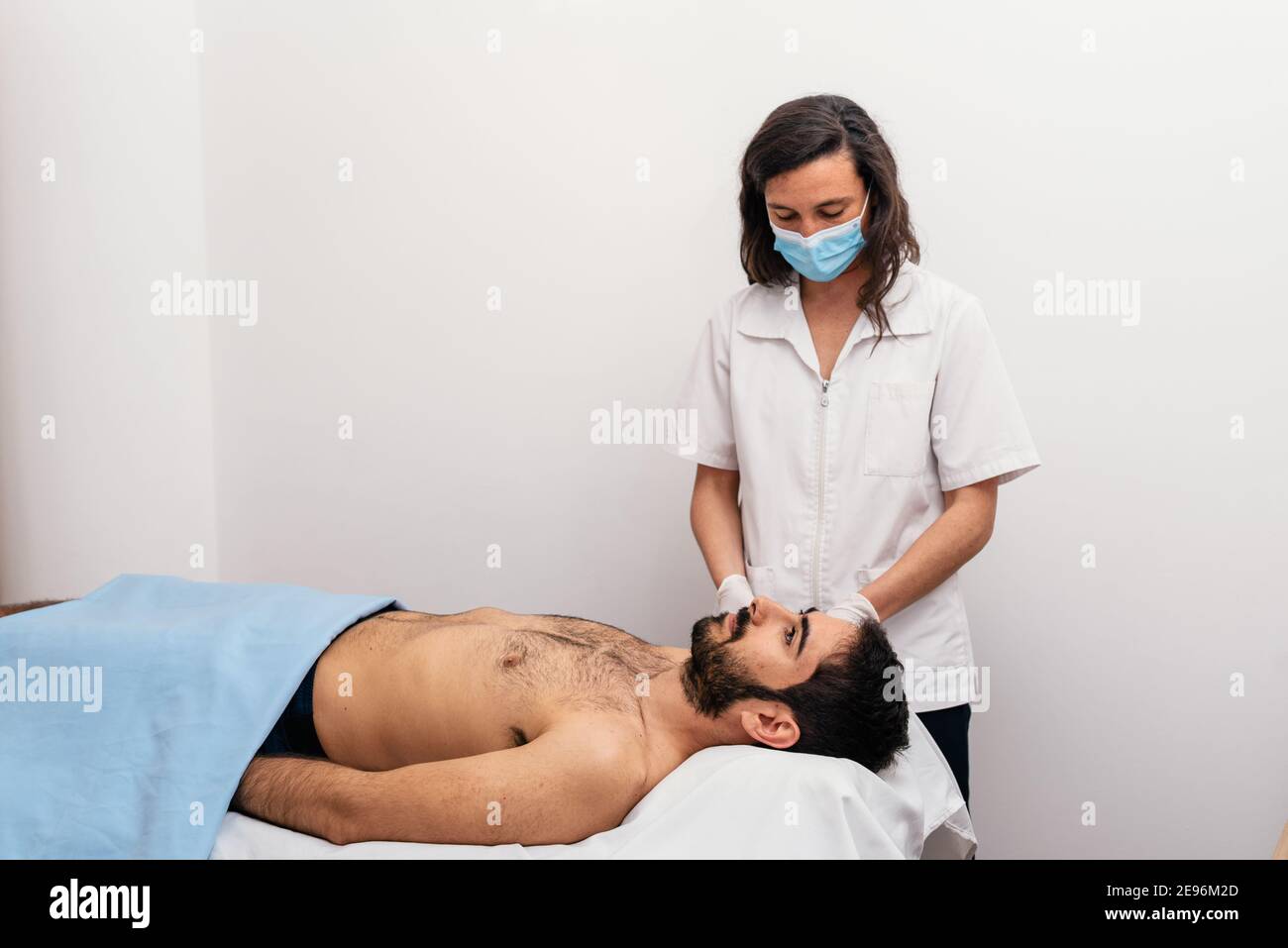 Stock photo of relax man receiving massage by physiotherapist ...