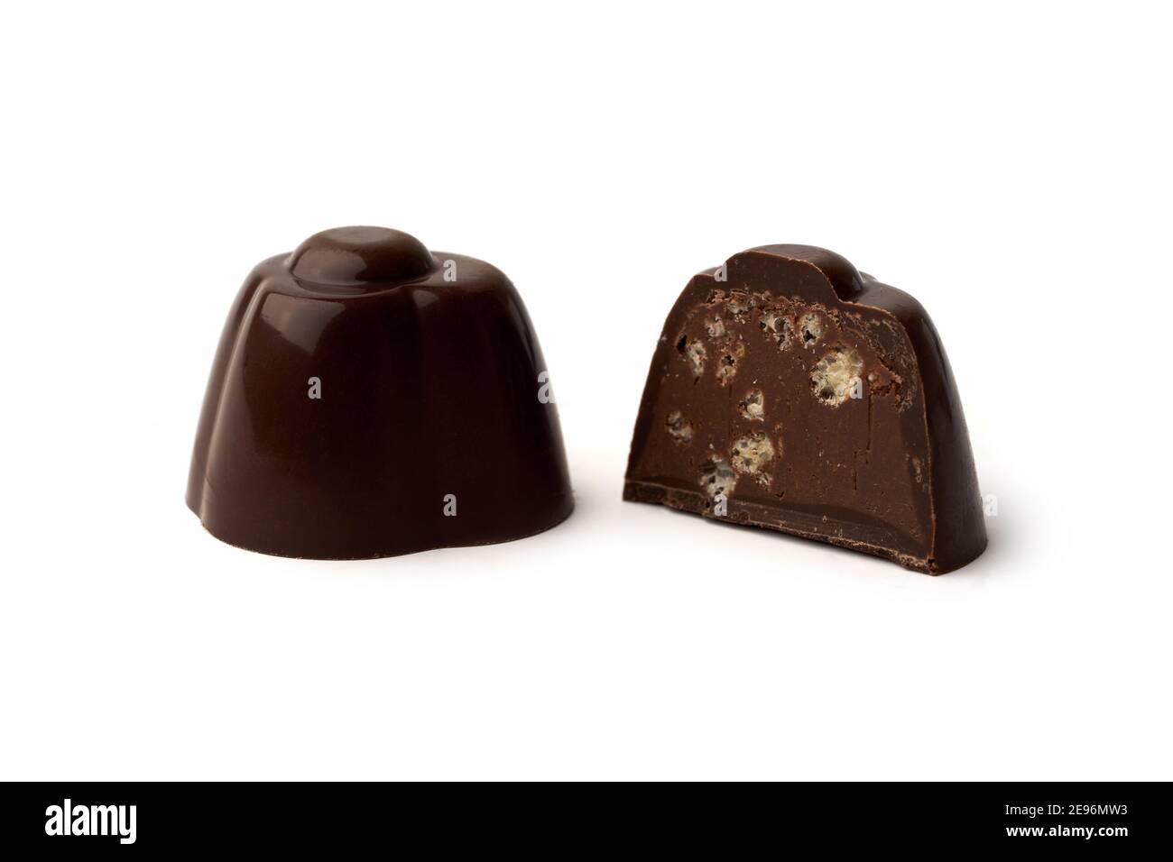 Close-up of one whole chocolate candy and half candy isolated on white ...