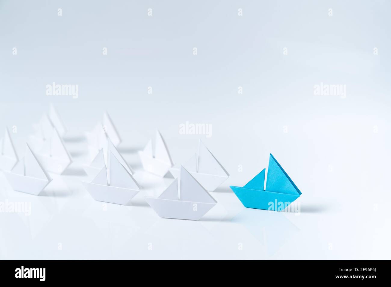 Leadership conceptual using blue paper ship Stock Photo - Alamy