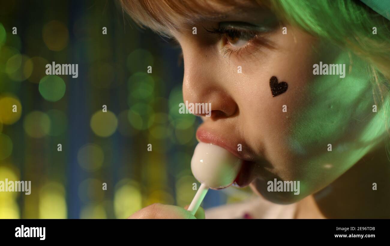 Close-up shot of stylish teenager caucasian kid girl lips licking ...