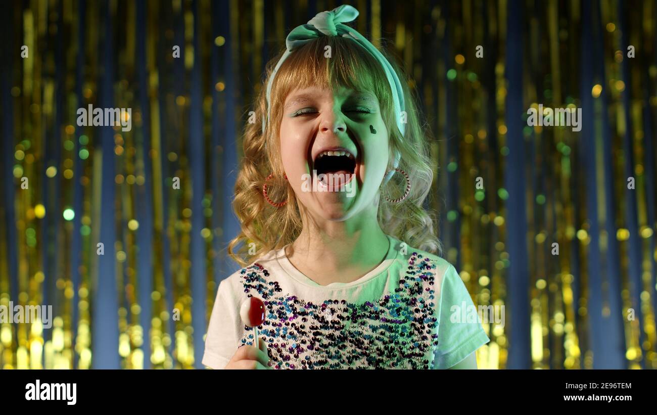 Trendy stylish girl with lollipop candy looking at camera smiling ...