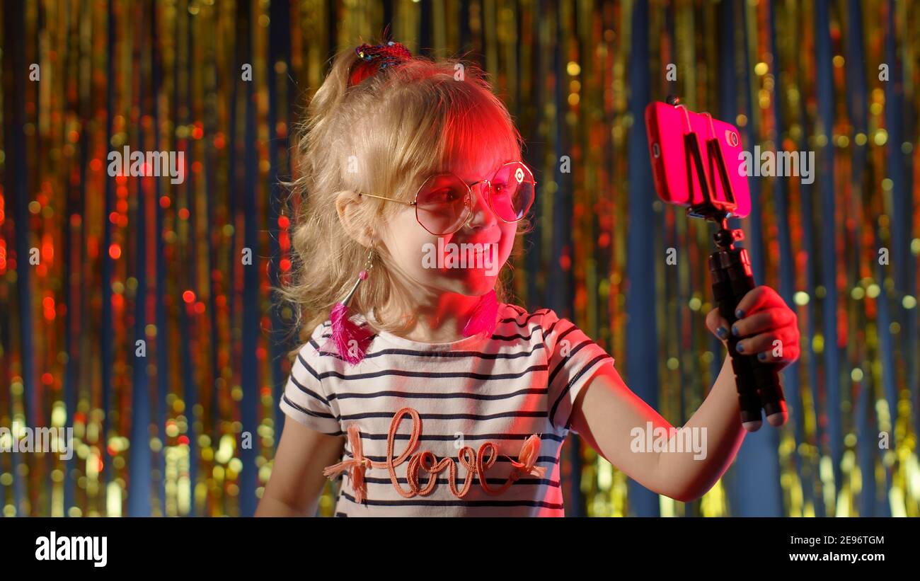 Trendy stylish child kid blogger smiling cheerfully, recording video ...