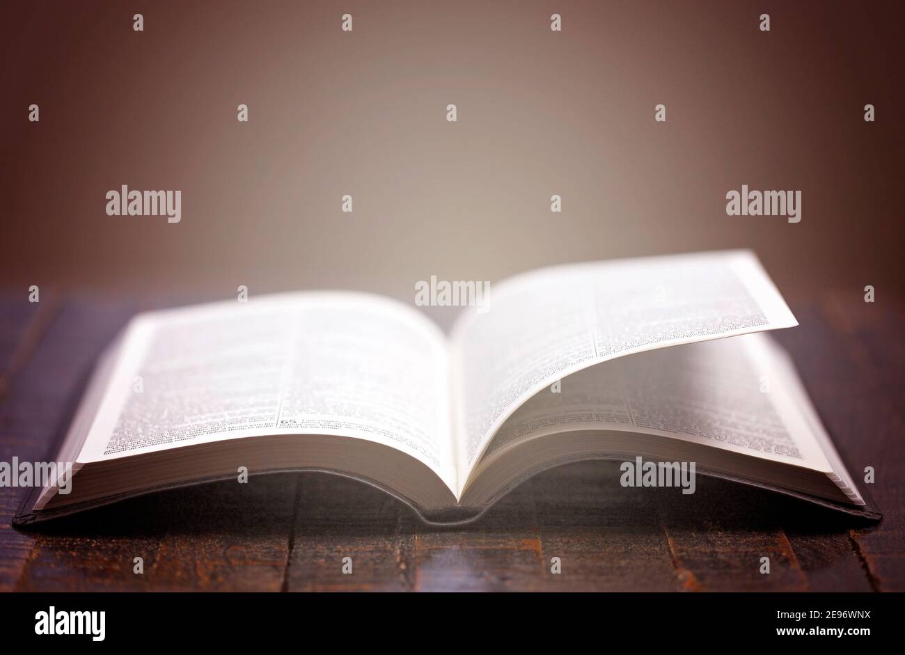 Bible Open on a Rustic Wooden Table with Pages Blowing Open Stock Photo ...
