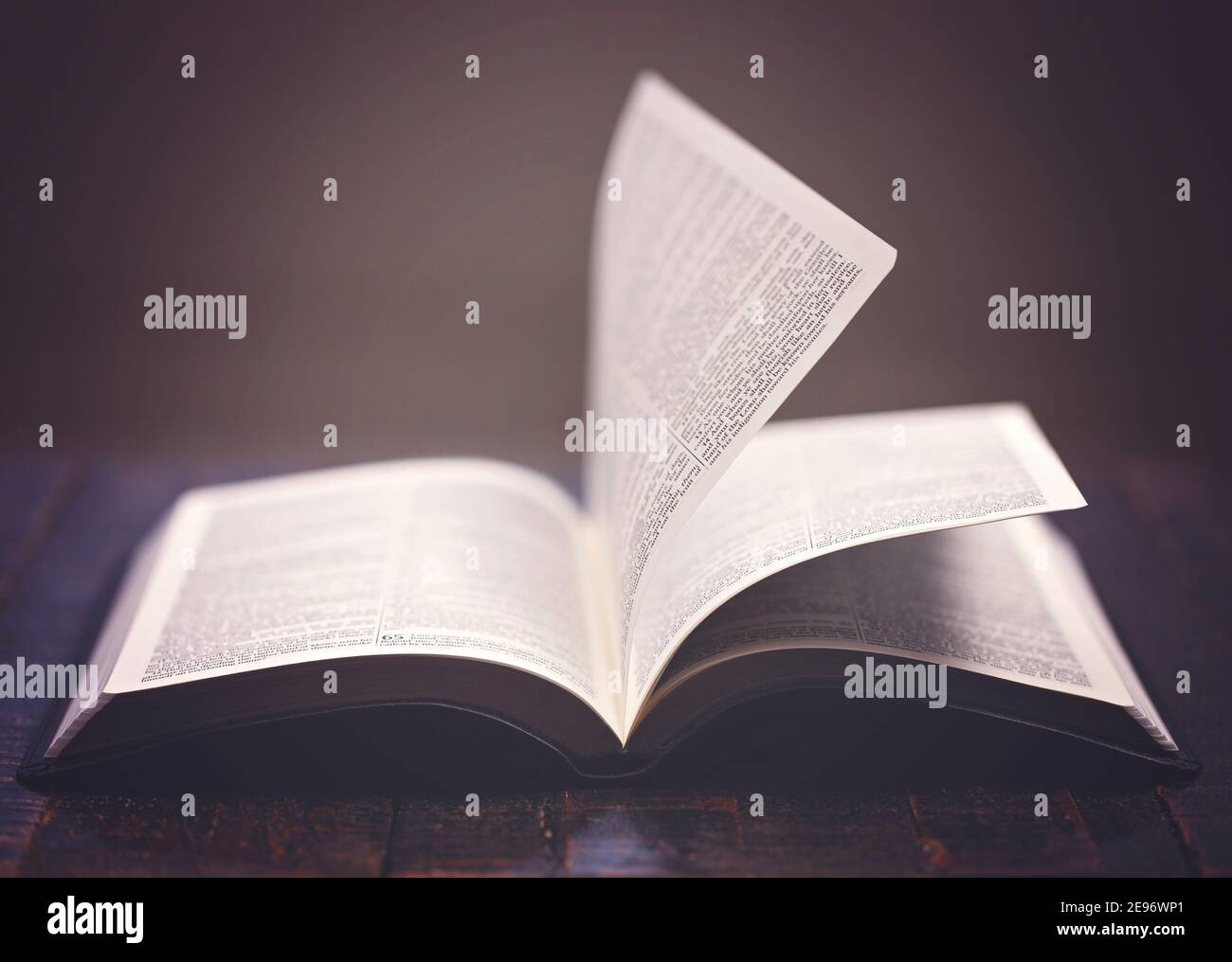 Bible Open on a Rustic Wooden Table with Pages Blowing Open Stock Photo ...