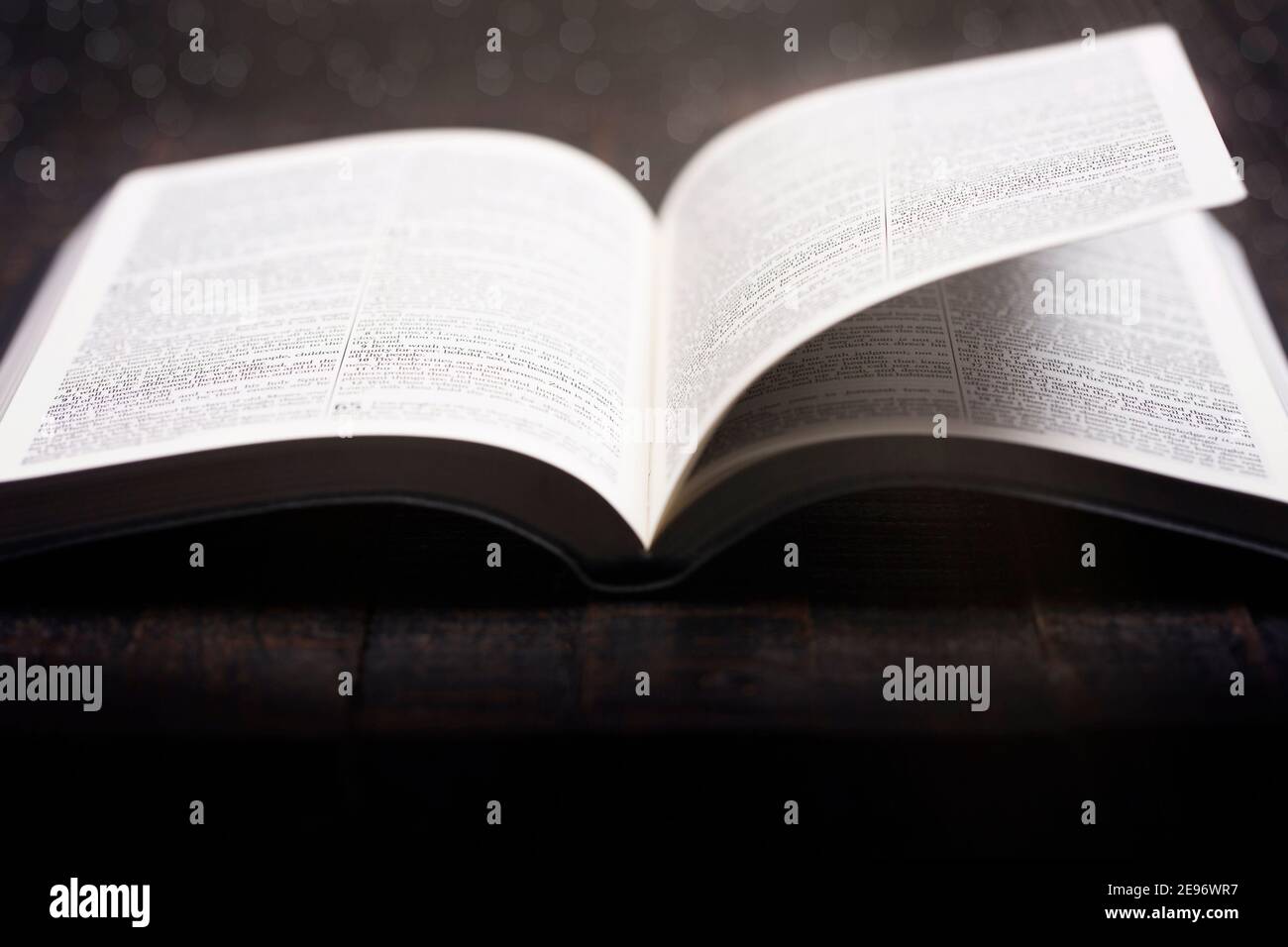 Bible Open on a Rustic Wooden Table with Pages Blowing Open Stock Photo ...